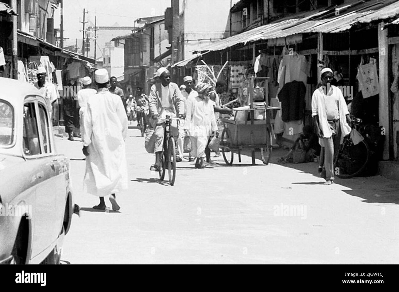 A business street. A number of men are visible on the street. A man ...