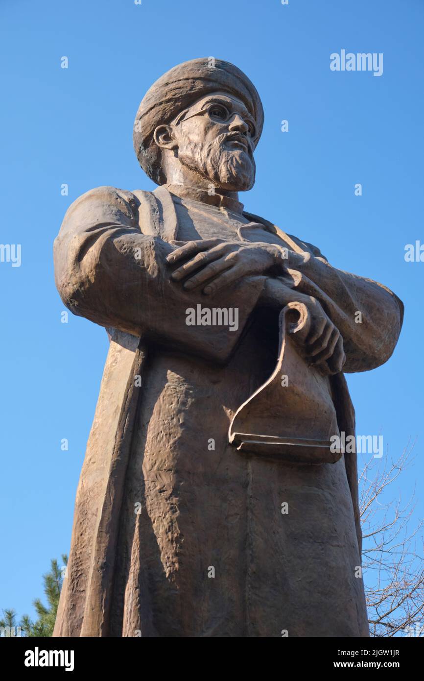 A bronze statue of a standing Behbudiy, famous writer. At Alisher Navoi ...