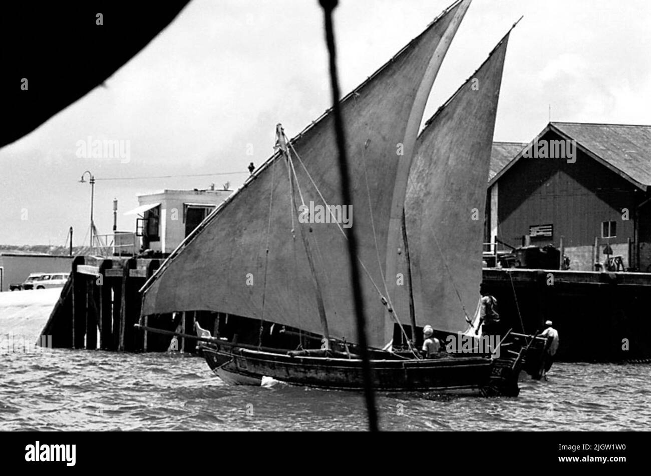 Two sailboats sail in a harbor. Several magazines are visible in the ...