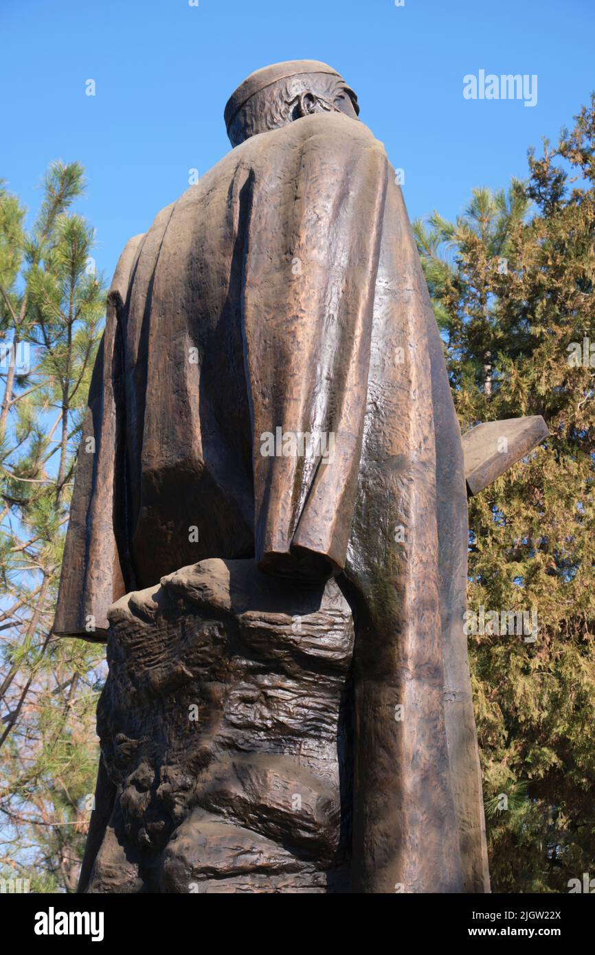 A bronze statue of a leaning Cholpán, famous writer and poet. At ...
