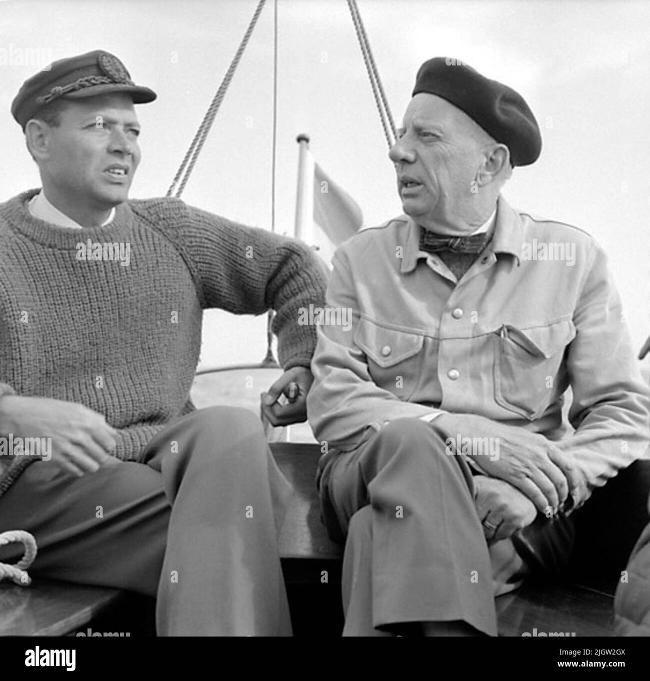 Two men and a sailing boat Black and White Stock Photos & Images - Alamy