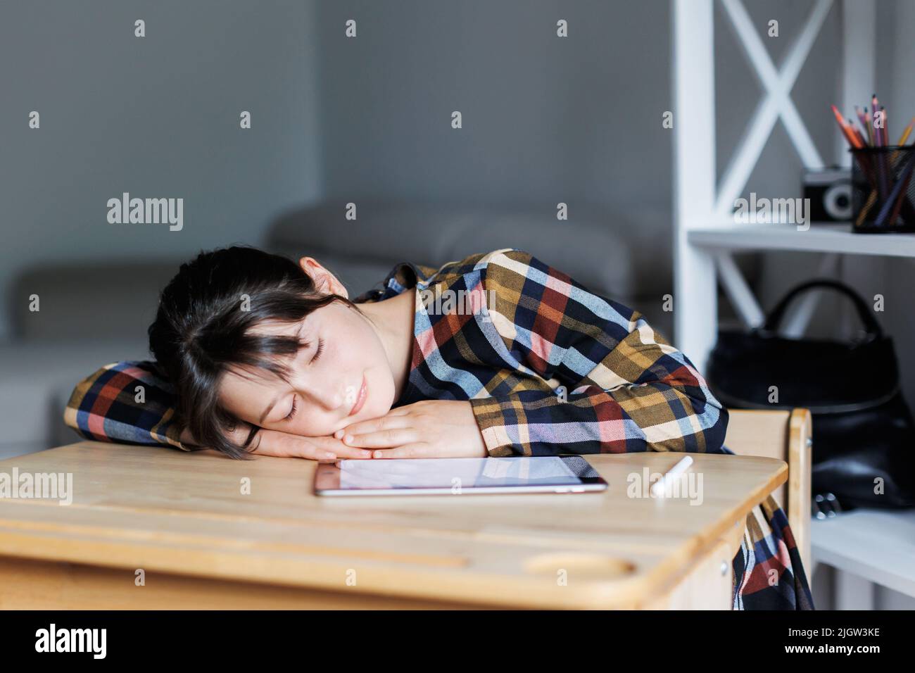 Tired and bored teenager school girl. Schoolgirl is sleeping while ...