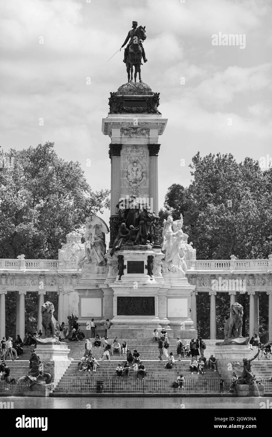 A vertical grayscale shot of the Monument to Alfonso XII in Retiro Park ...