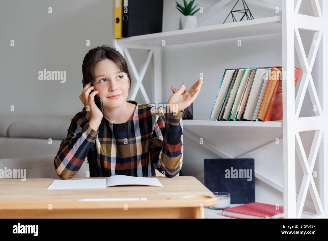 Happy teen girl talking on her cell phone during an class. Portrait of ...