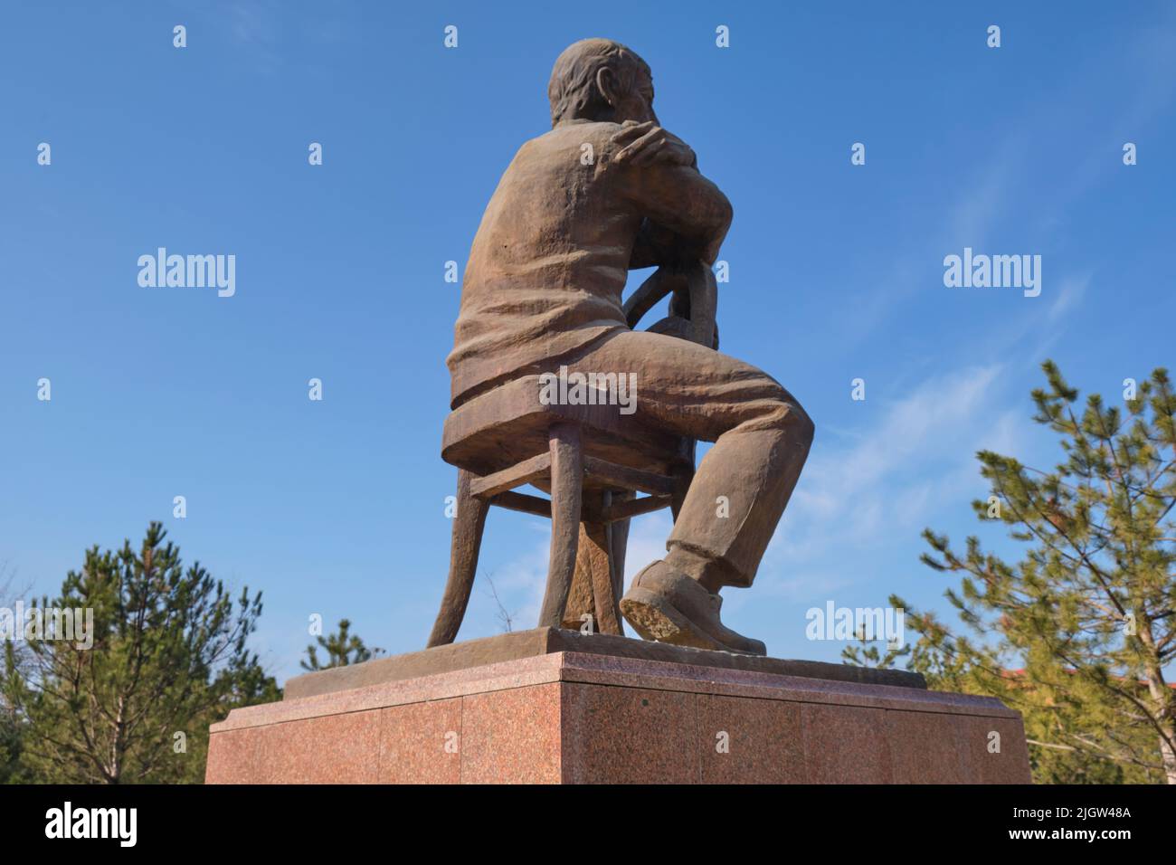 A bronze statue of a sitting Aleksandr Faynberg, famous writer and poet ...