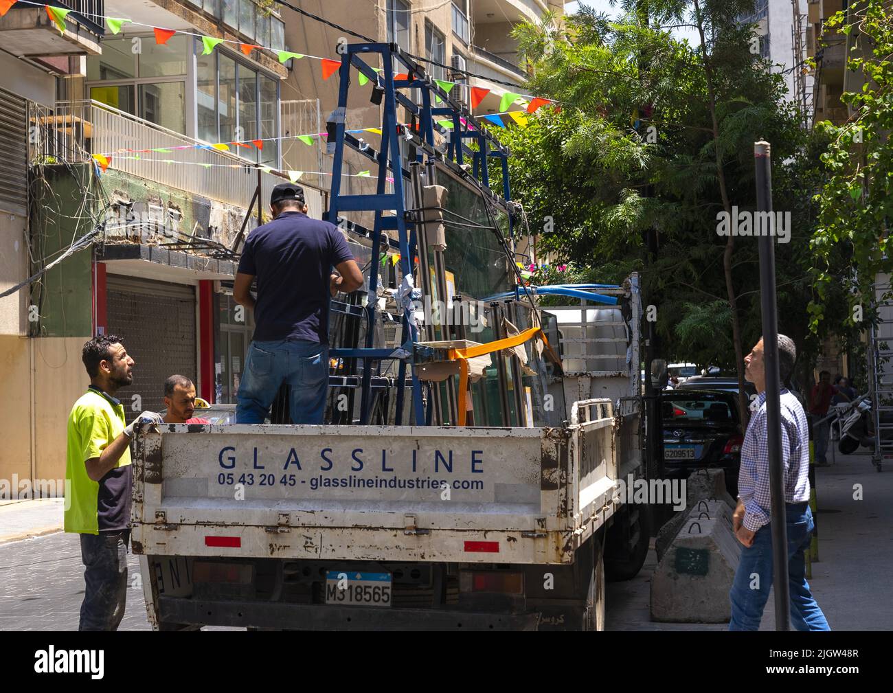 Syrian workers carrying new windows after the port explosion, Beirut ...