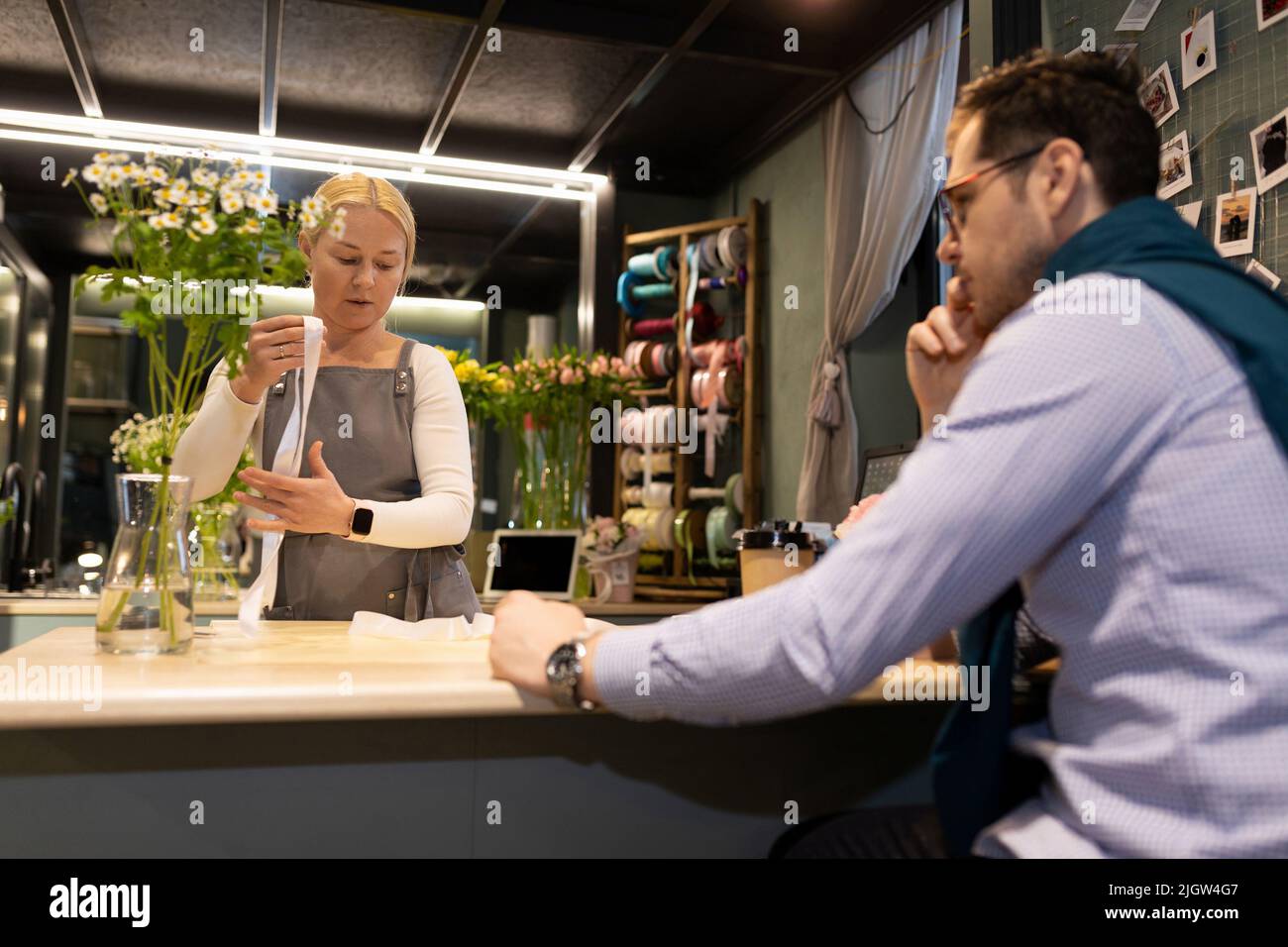 a regular customer waits with a tincture for the store employee to ...