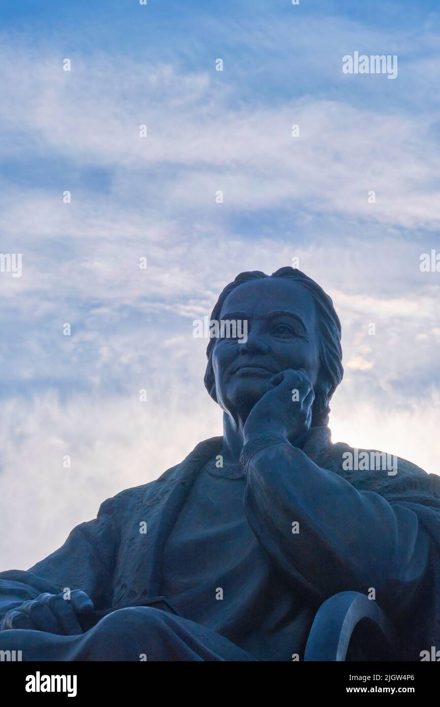 A bronze statue of a sitting Zulfiya, famous woman writer and poet. At ...