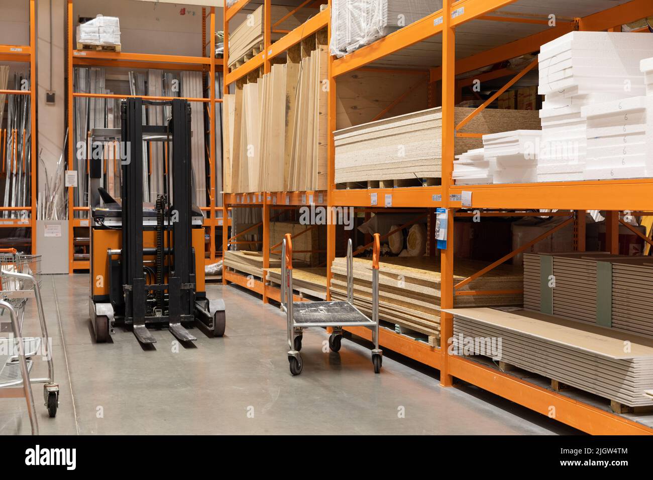 interiors of a shop selling lumber and planks with a loader in the ...