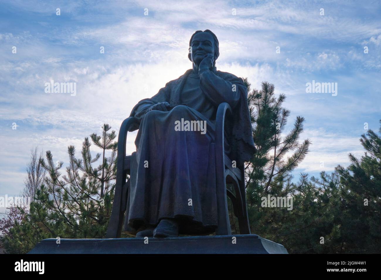 A bronze statue of a sitting Zulfiya, famous woman writer and poet. At ...