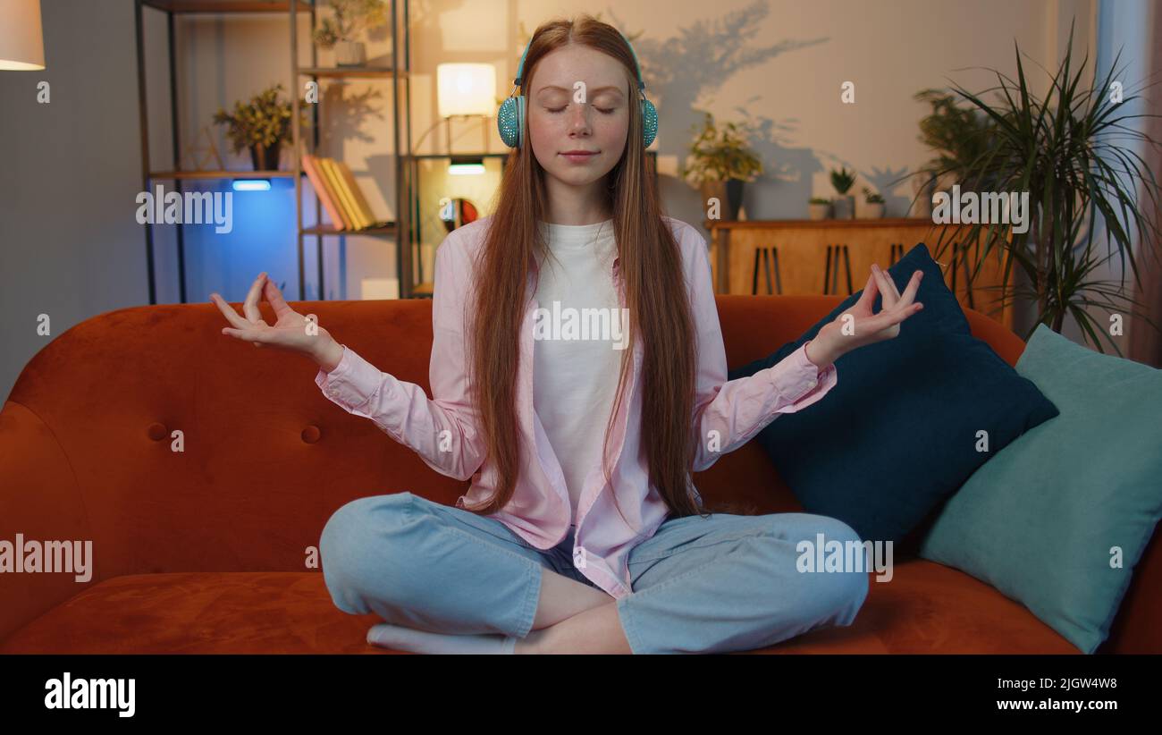 Keep calm down, relax, inner balance. Young redhead child girl breathes ...