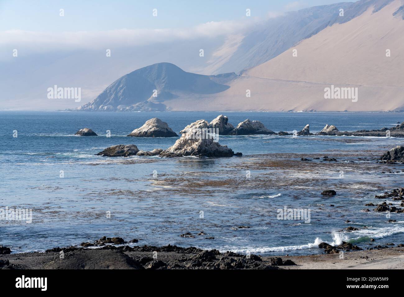 Giant sand dunes slope down from the Coast Range to the Pacific Ocean ...