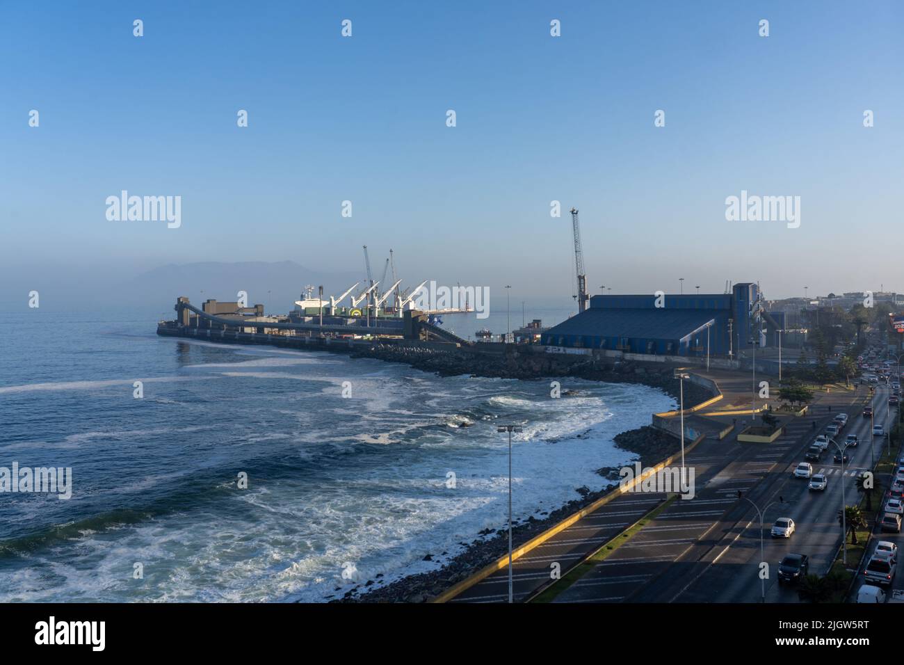 A bulk cargo freighter at in the loading dock of the harbor at ...