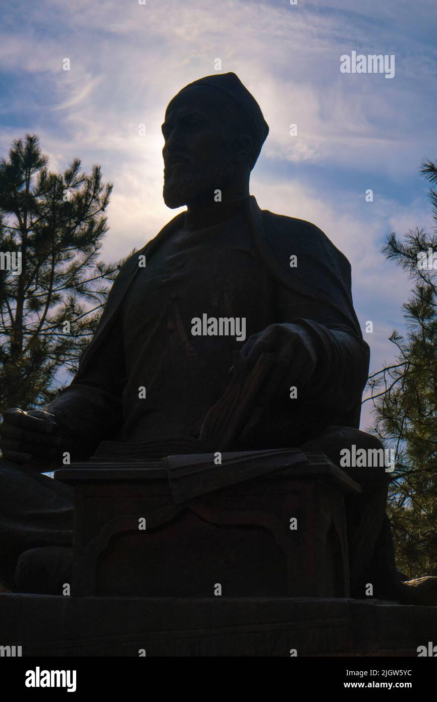 A bronze statue of a sitting Muqimiy, famous writer and critic. At ...