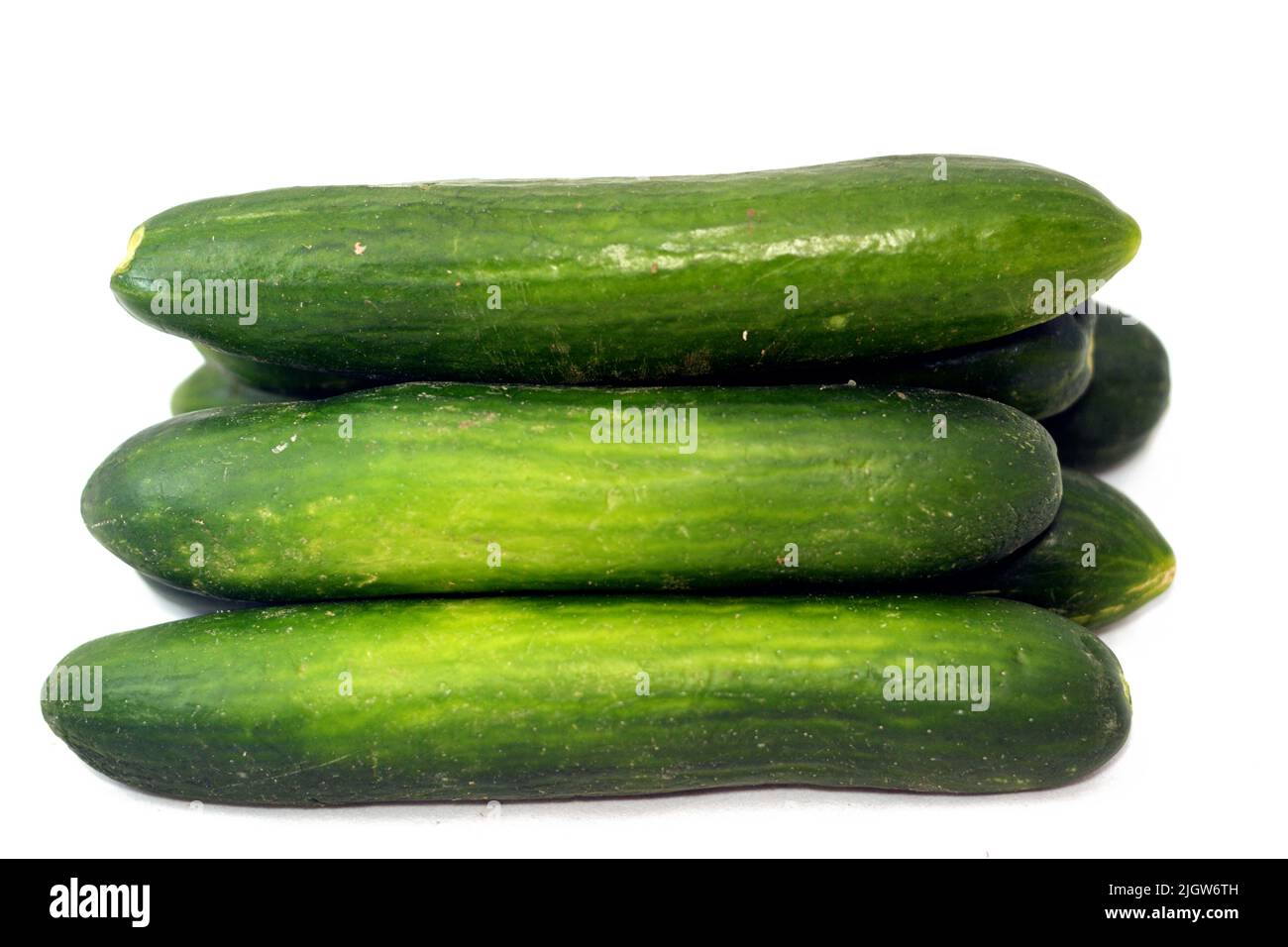 Pile of fresh green cucumbers vegetables isolated on white background ...
