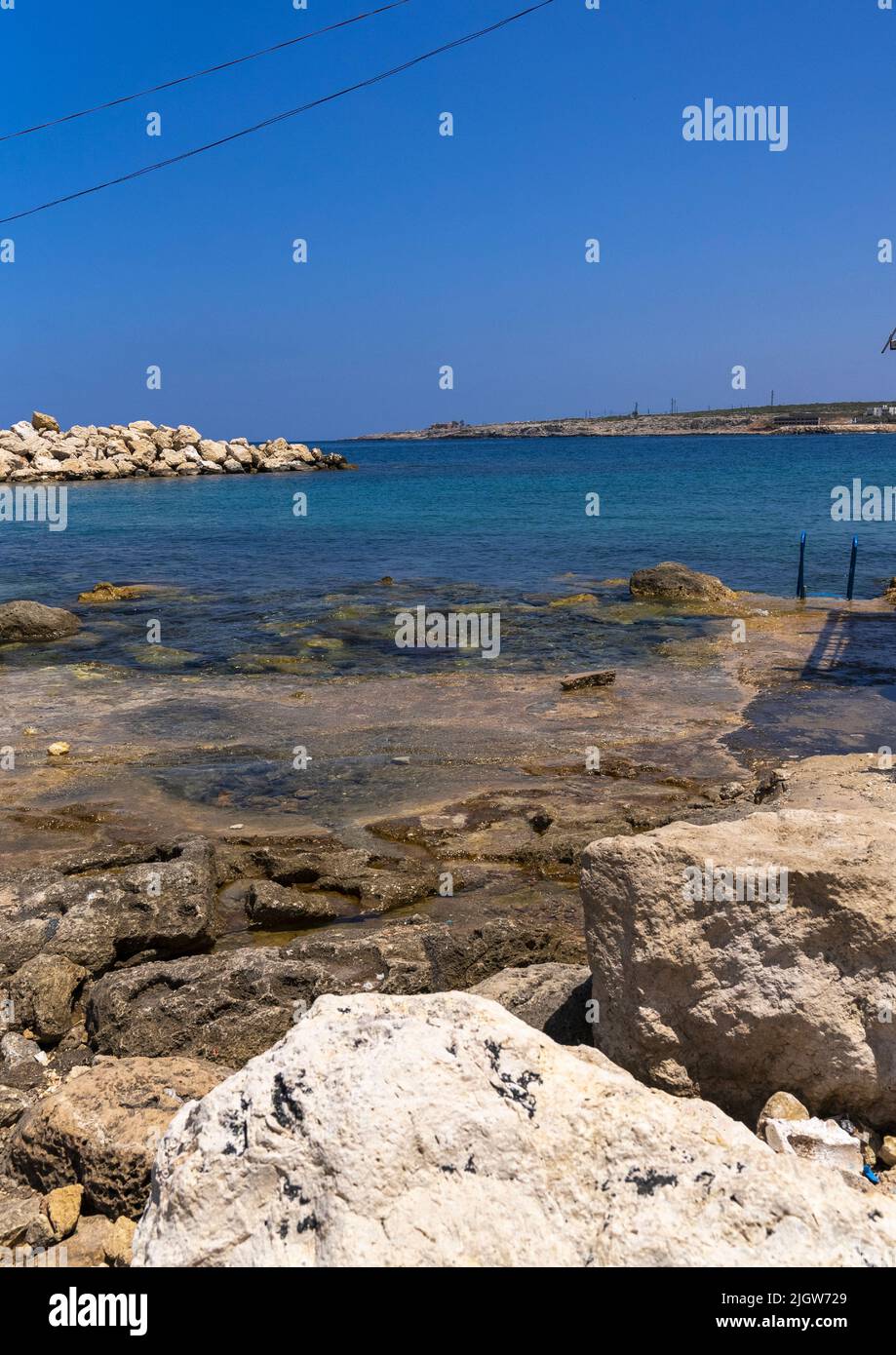 Seashore with blue water, North Governorate, Anfeh, Lebanon Stock Photo ...