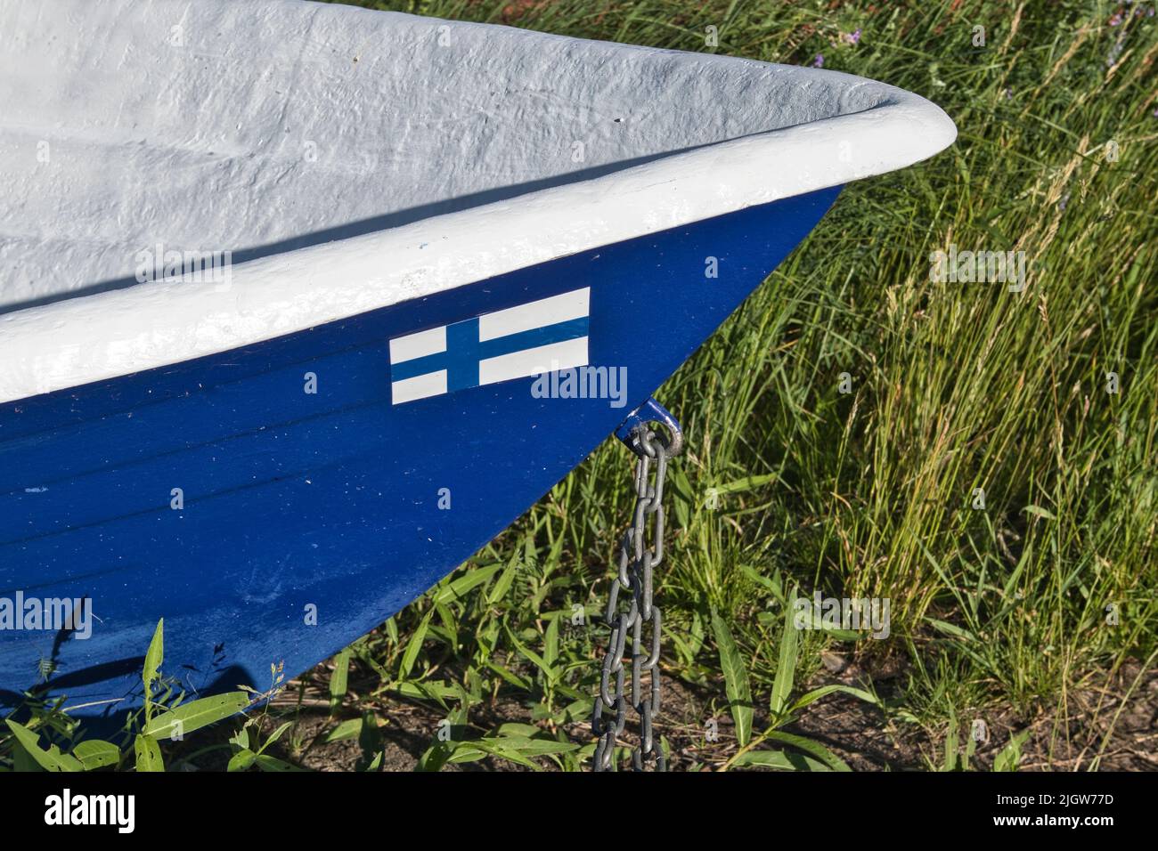Finnish flag painted on a bow of a small boat Stock Photo - Alamy