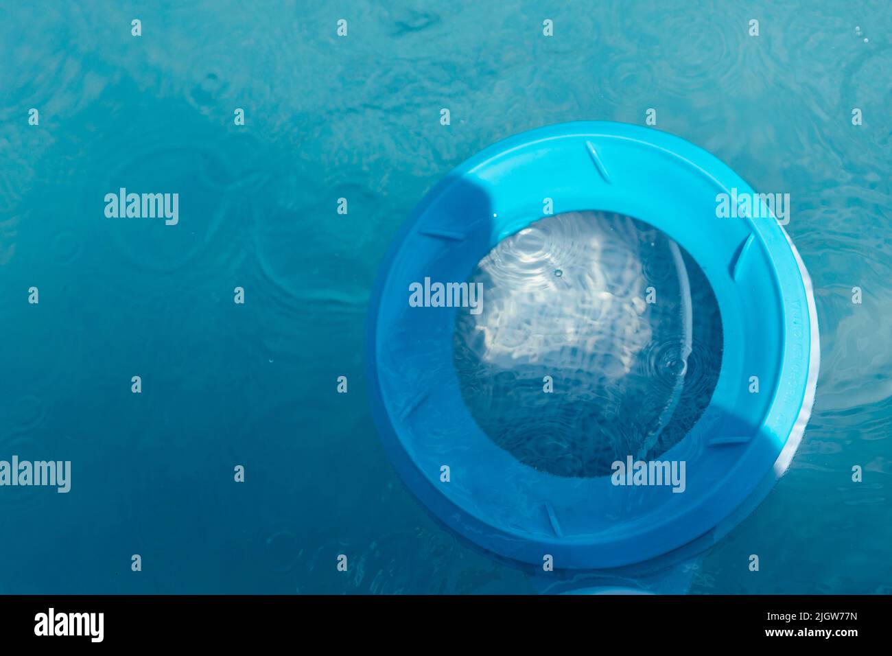 Top view of the skimmer for cleaning the pool in clear water. Close-up ...