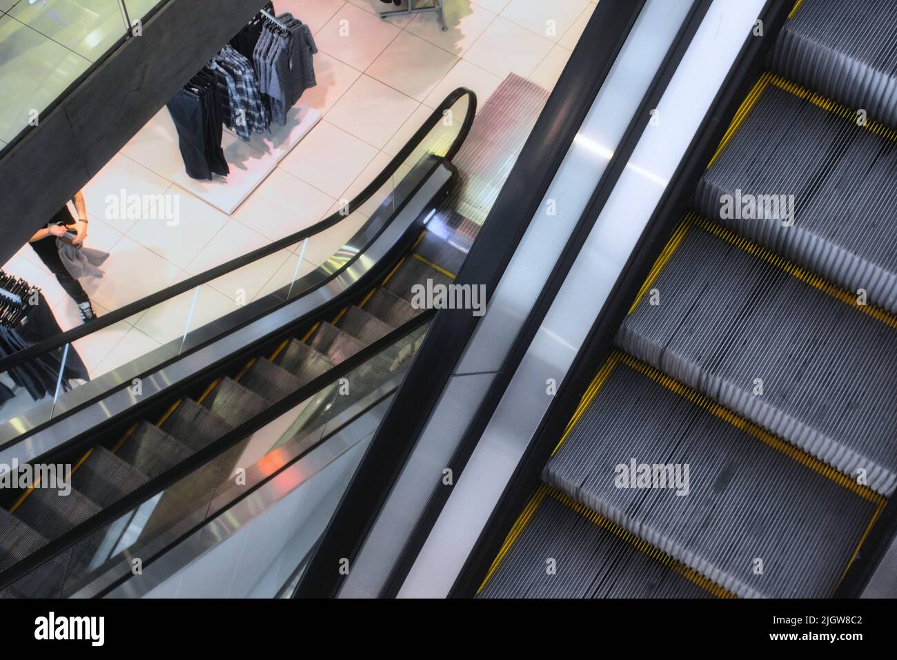 Escalators in a clothes shop in a department store or shopping mall ...