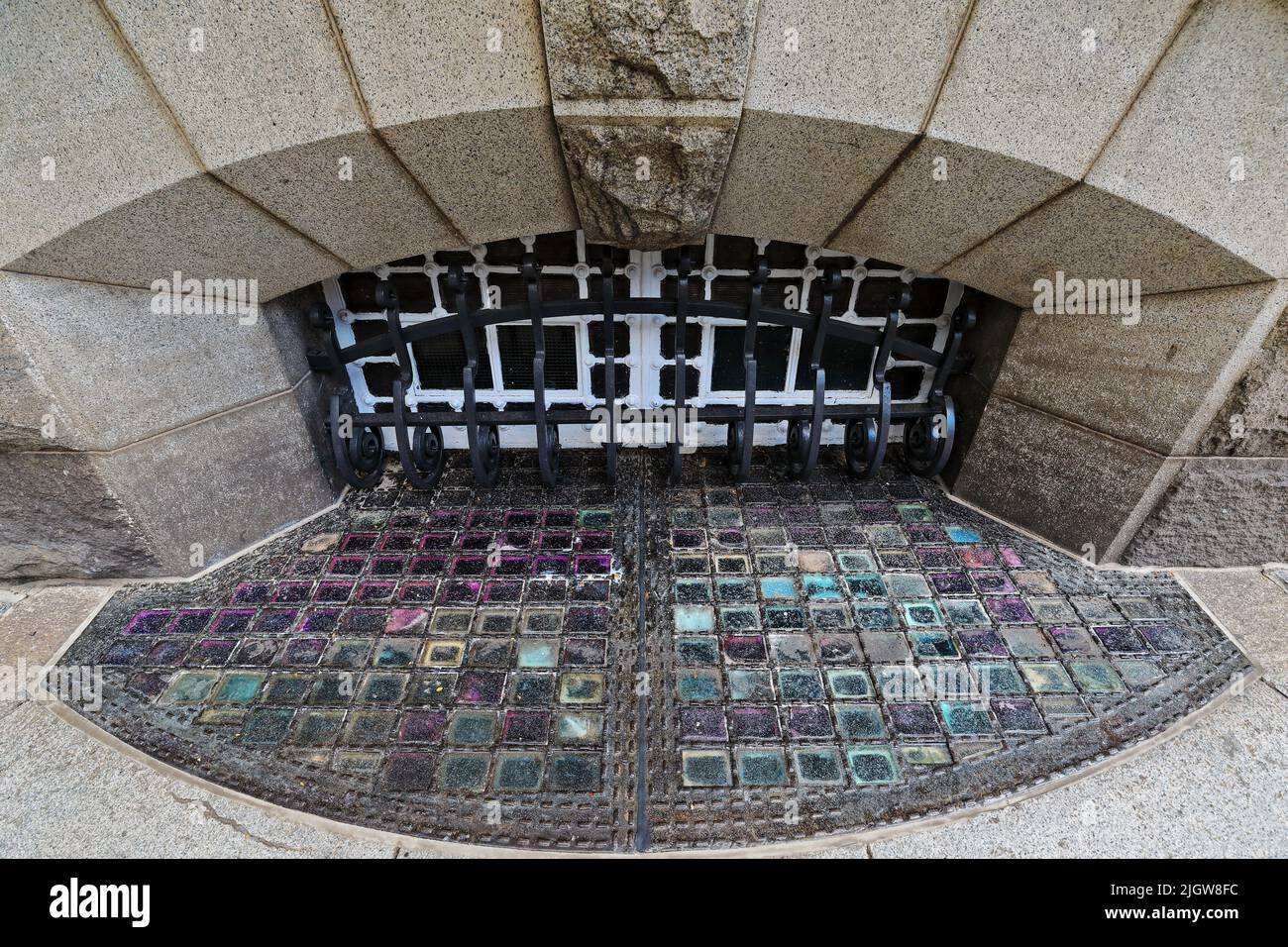 048 Arched basement window with decorative iron grillwork and colored ...