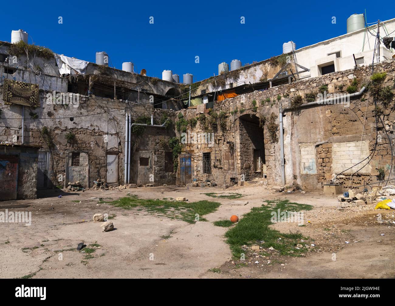 Courtyard of an old caravanserai occupied by poor people, North ...