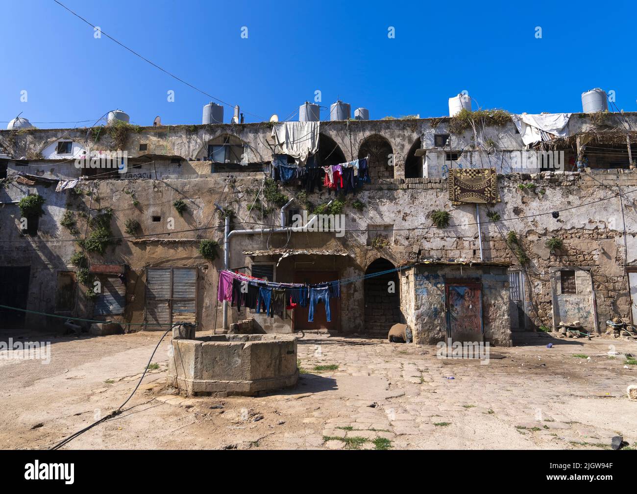 Courtyard of an old caravanserai occupied by poor people, North ...