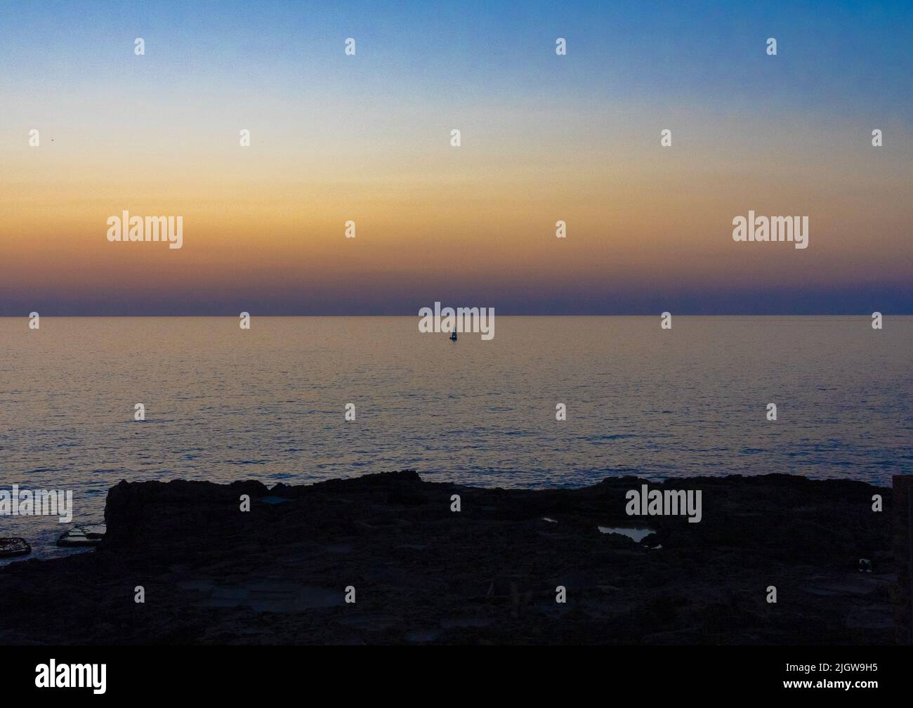 Boat sailing at sunset, North Governorate, Batroun, Lebanon Stock Photo ...