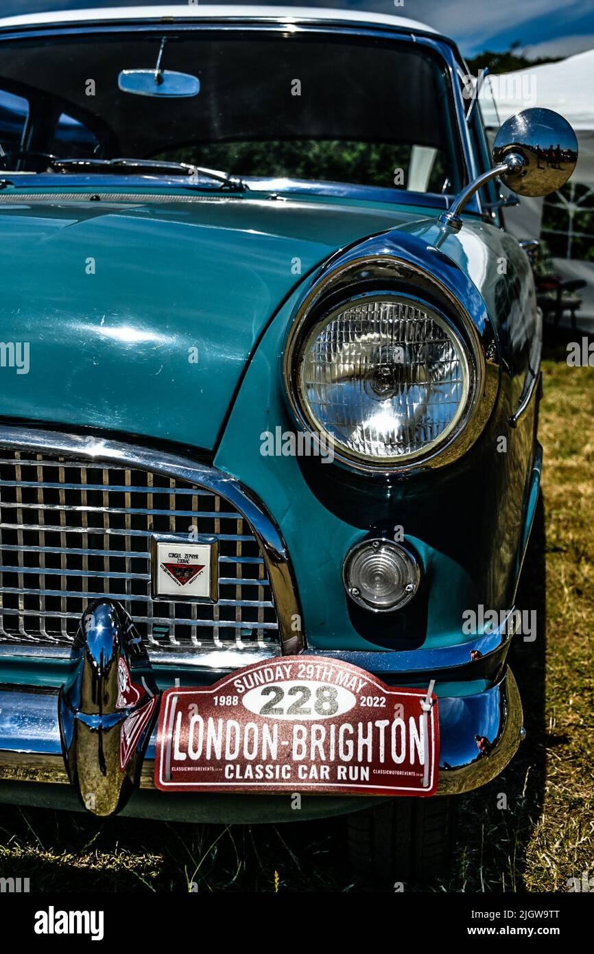 The vertical view of a blue Mini cooper classic car parked outdoors ...