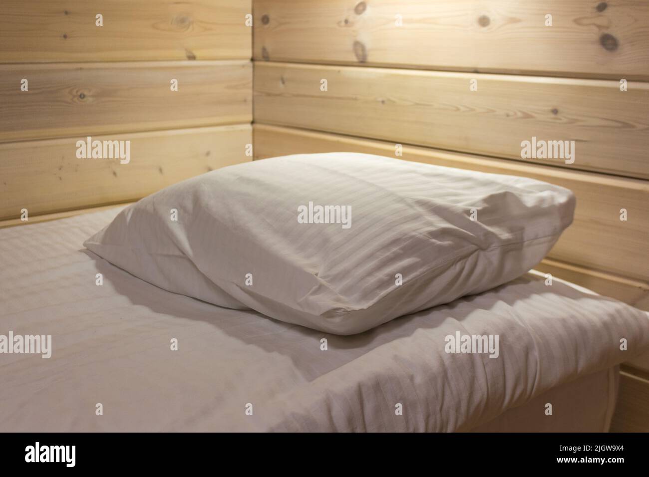 Prepared fresh bed in a wooden house, scene in hotel room. Horizontal ...
