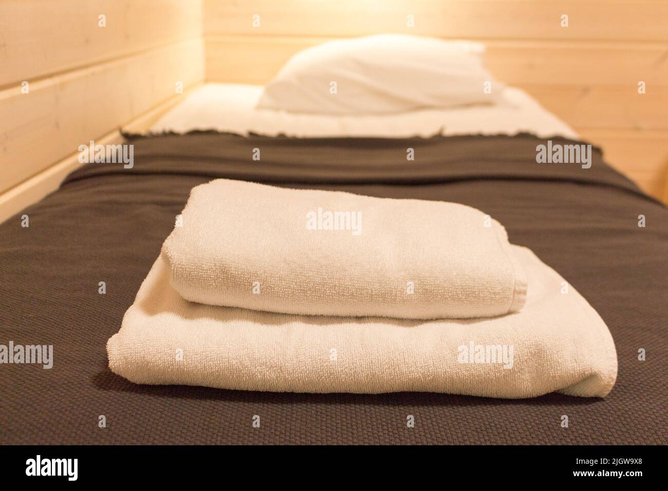 Prepared fresh bed in a wooden house, scene in hotel room. Horizontal ...