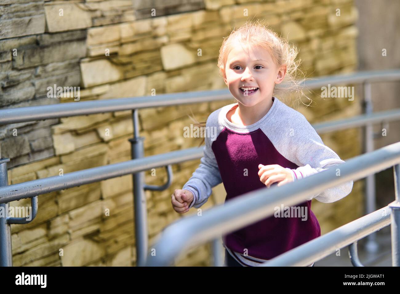 Cute happy caucasian girl running and smiling Stock Photo - Alamy