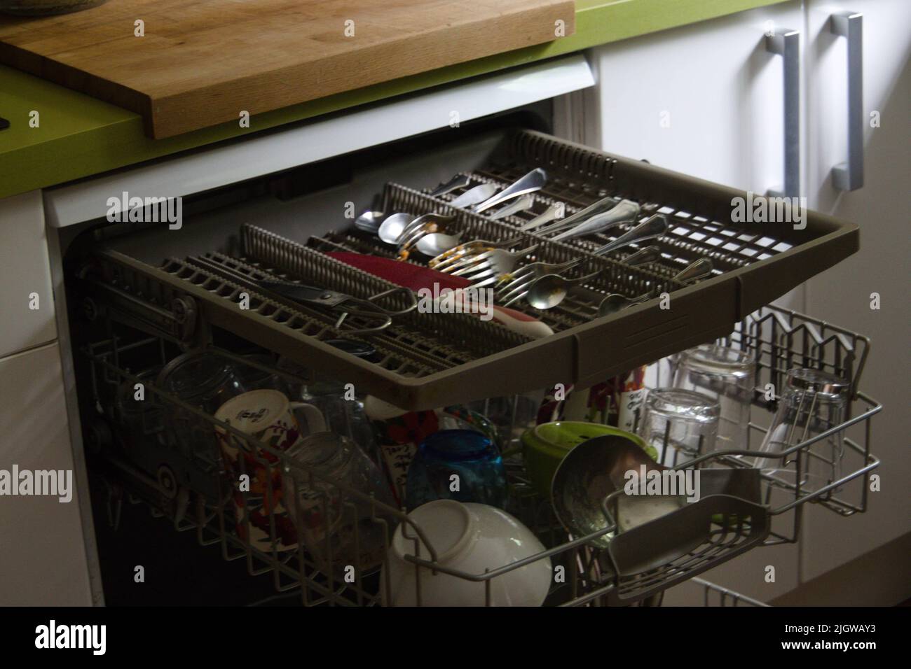 An open dishwasher machine with clean cutlery and dishware Stock Photo ...