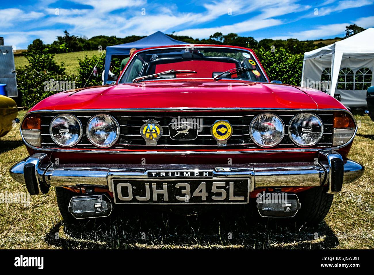 The red Triumph Stag classic car parked outdoors on the grass Stock ...