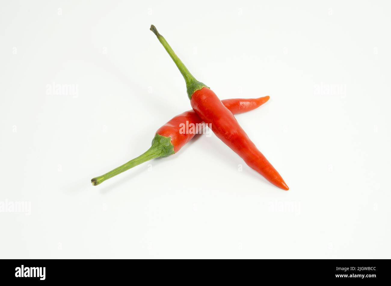 Two of ripe fruits of red chilli peppers spicy isolated on white ...