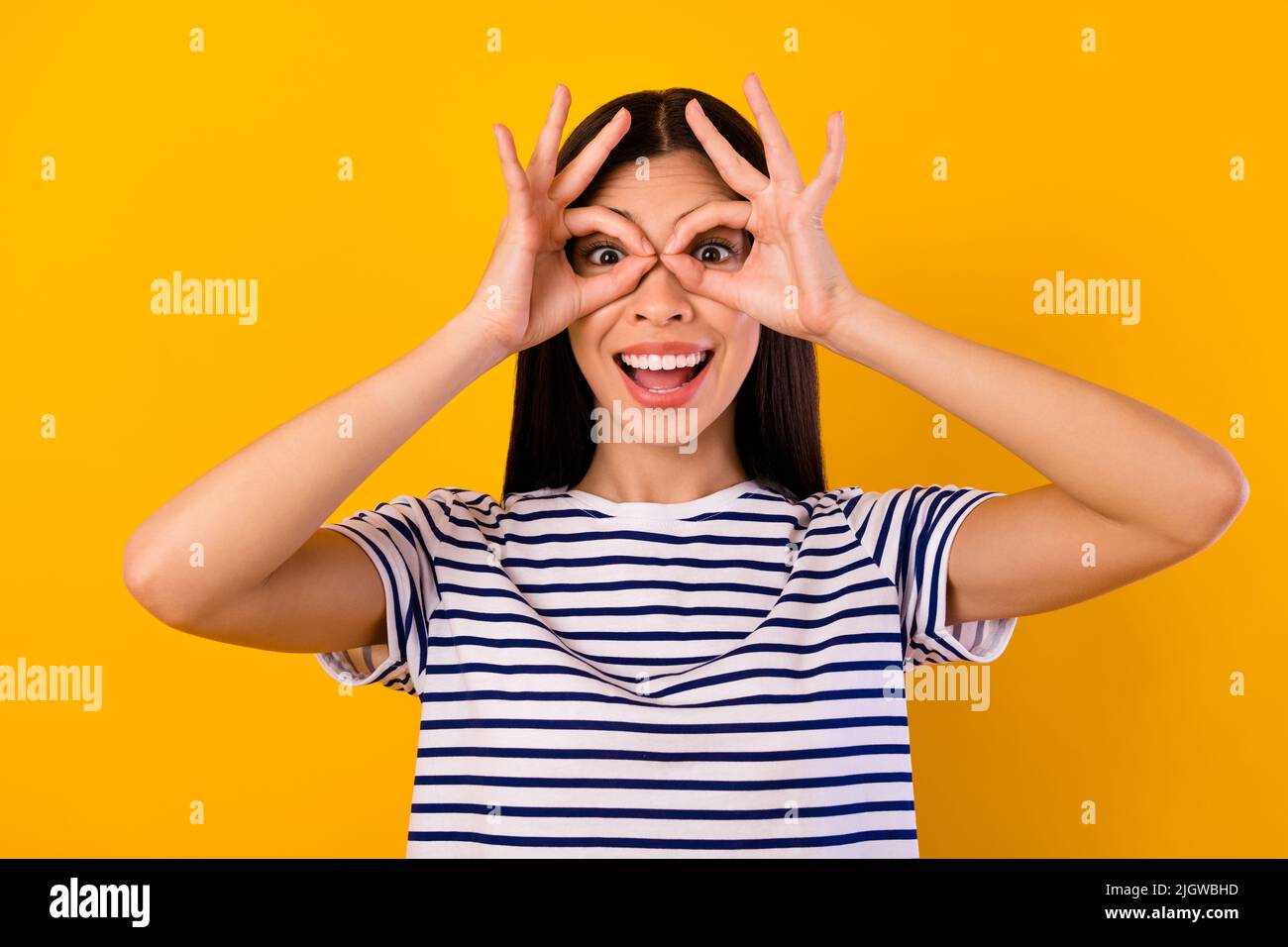 Photo of fooling funny girl dressed striped clothes showing okey signs ...