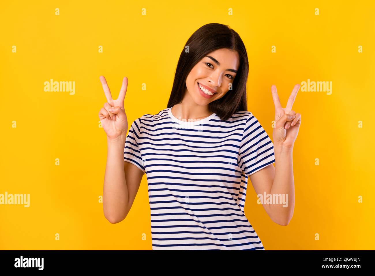 Photo of cheerful lovely indonesian person hands fingers demonstrate v ...