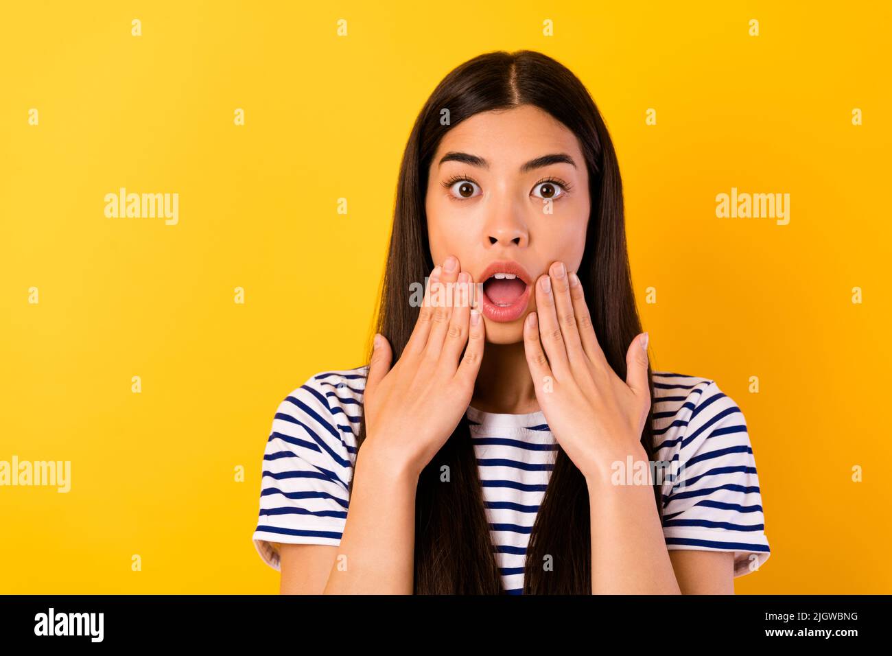 Portrait of shocked malaysian lady hands touch cheeks open mouth ...