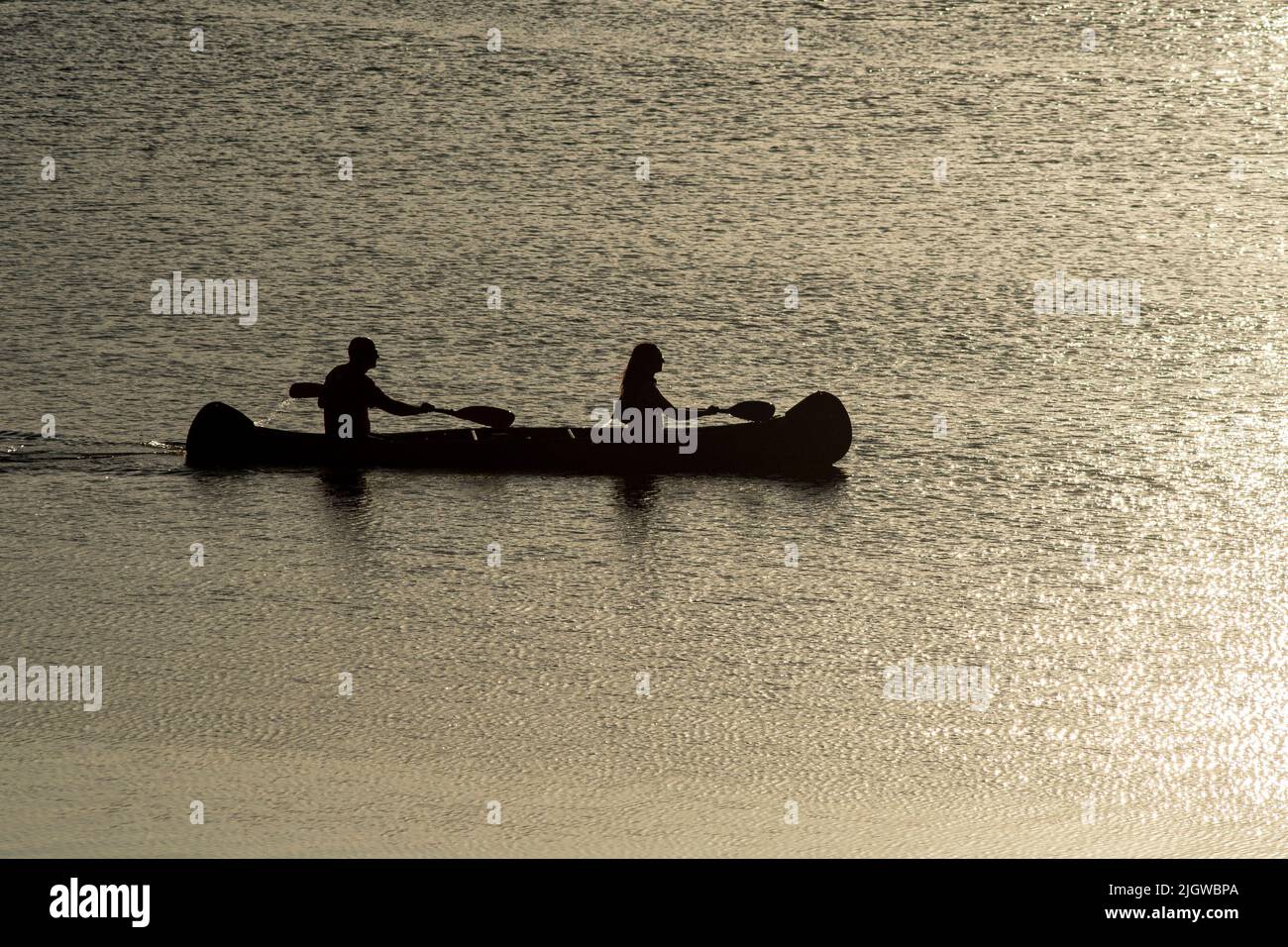 A silhouette of people floating on boat in sea Stock Photo - Alamy