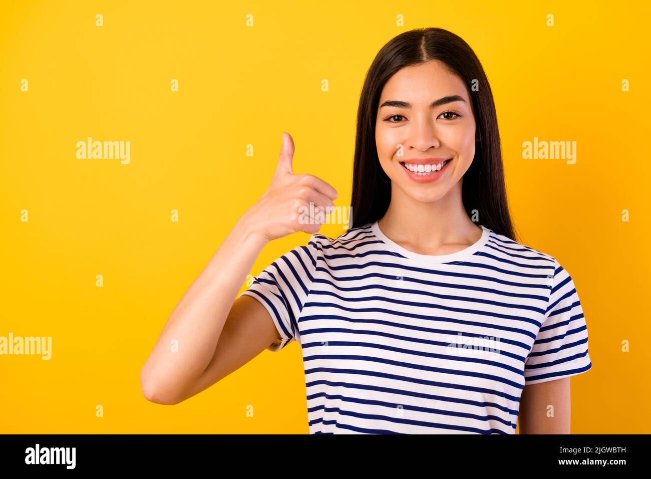Photo of positive lovely filipino girl arm finger shot thumb up toothy ...