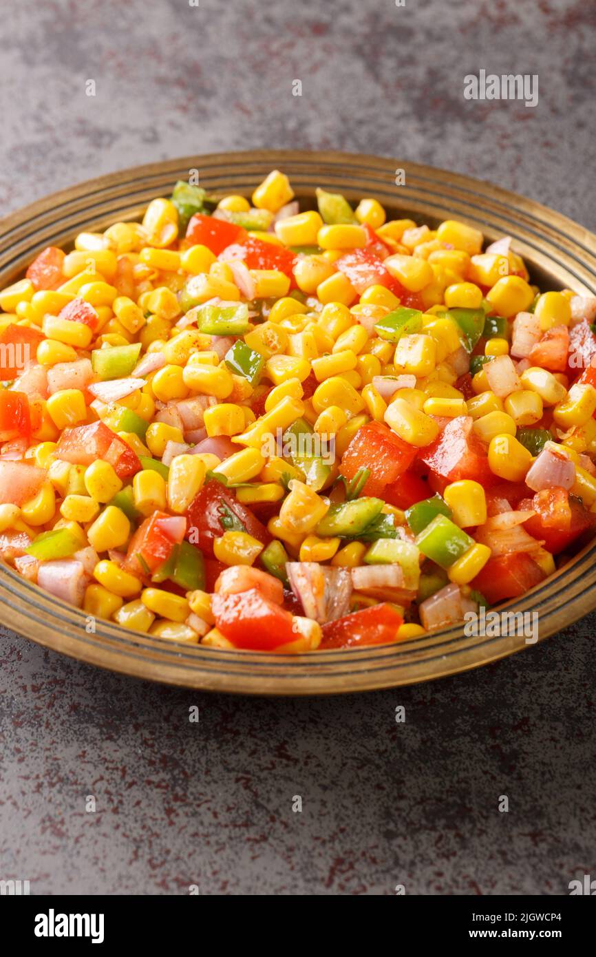 Spicy Sweet Corn Chaat in indian style served on a plate closeup on the ...