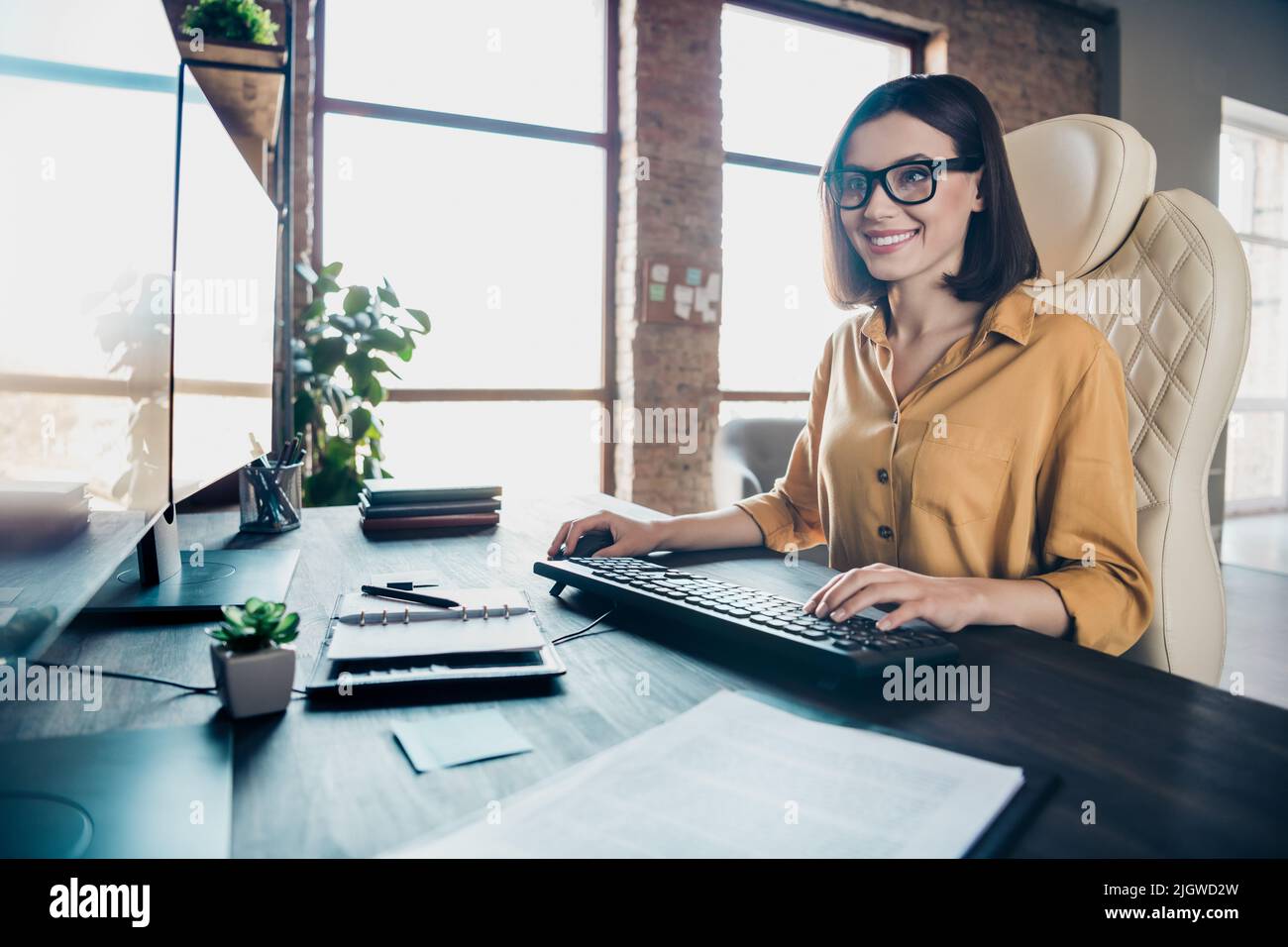 Portrait of attractive cheerful focused girl preparing presentation ...