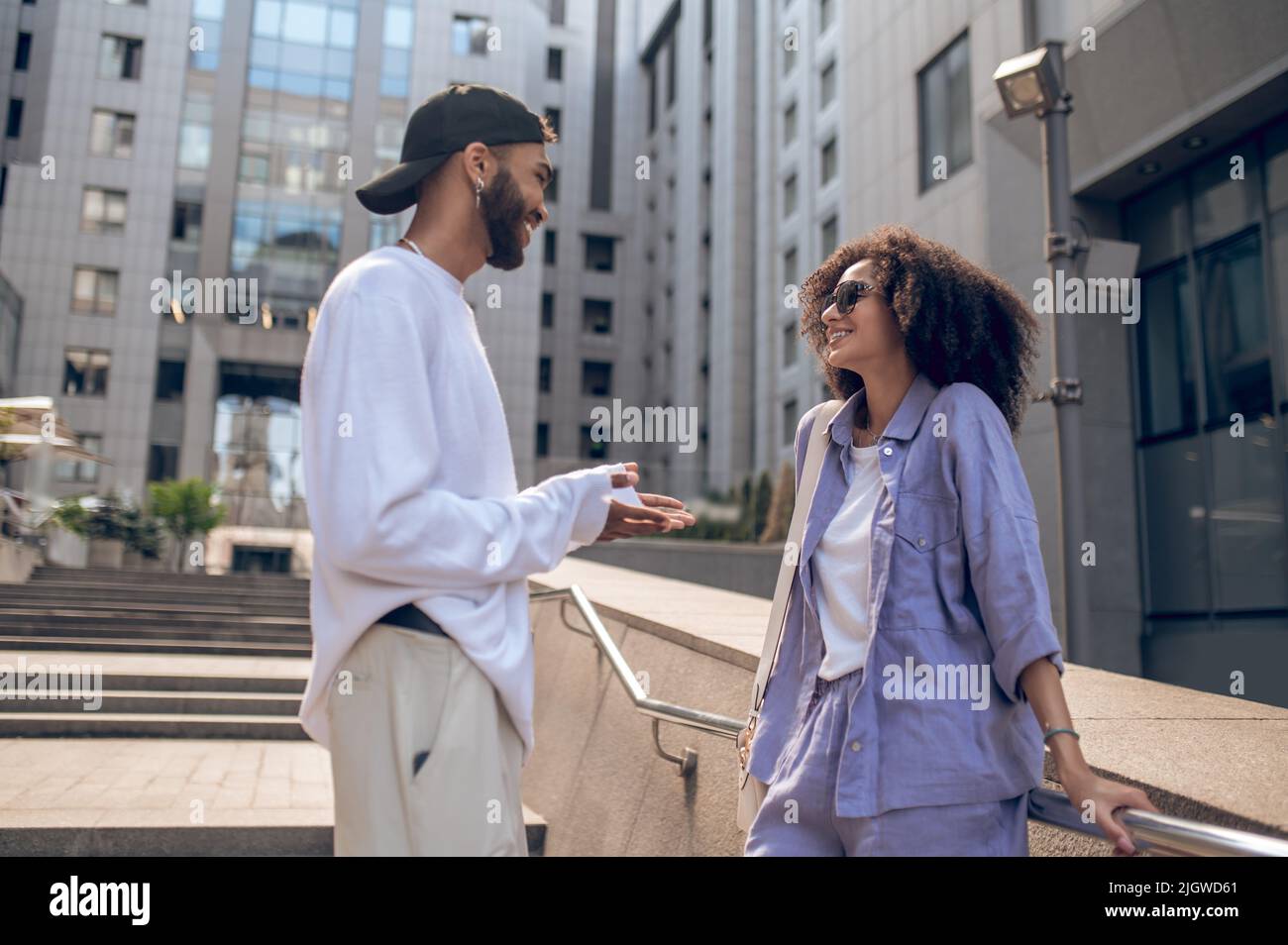 Young man and young woman flirting and looking excited Stock Photo - Alamy