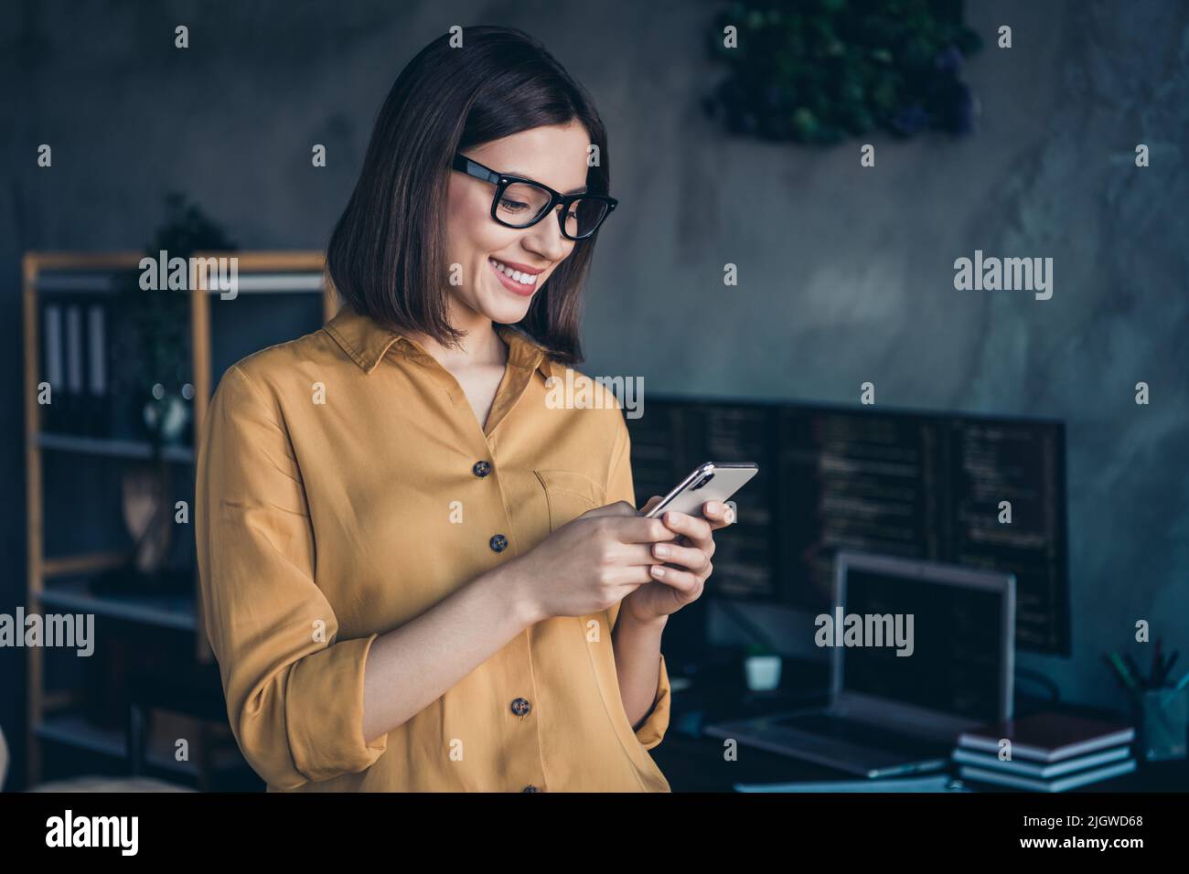 Portrait of attractive focused cheerful girl expert using device gadget ...