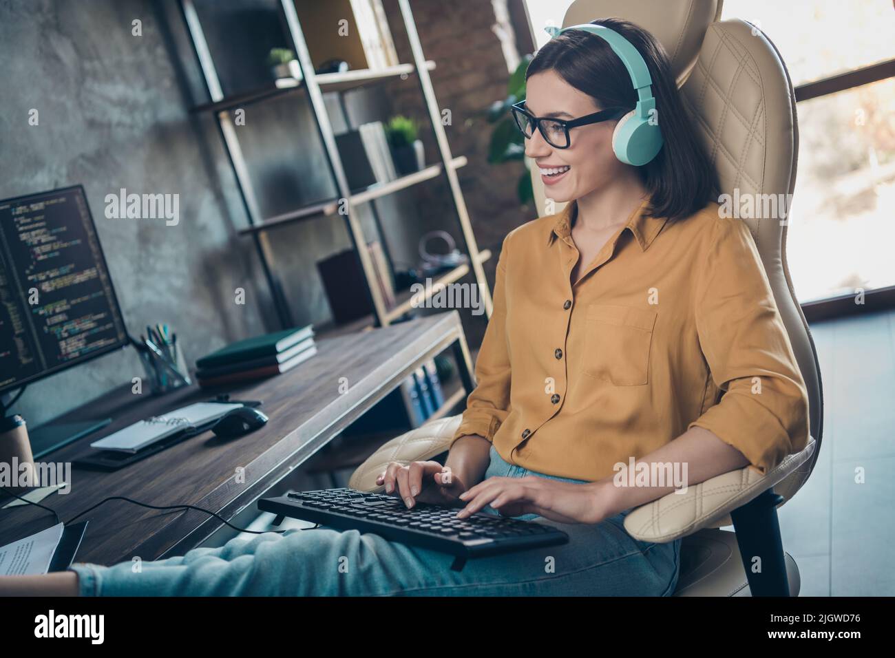 Portrait of attractive cheery skilled focused girl geek nerd writing ...