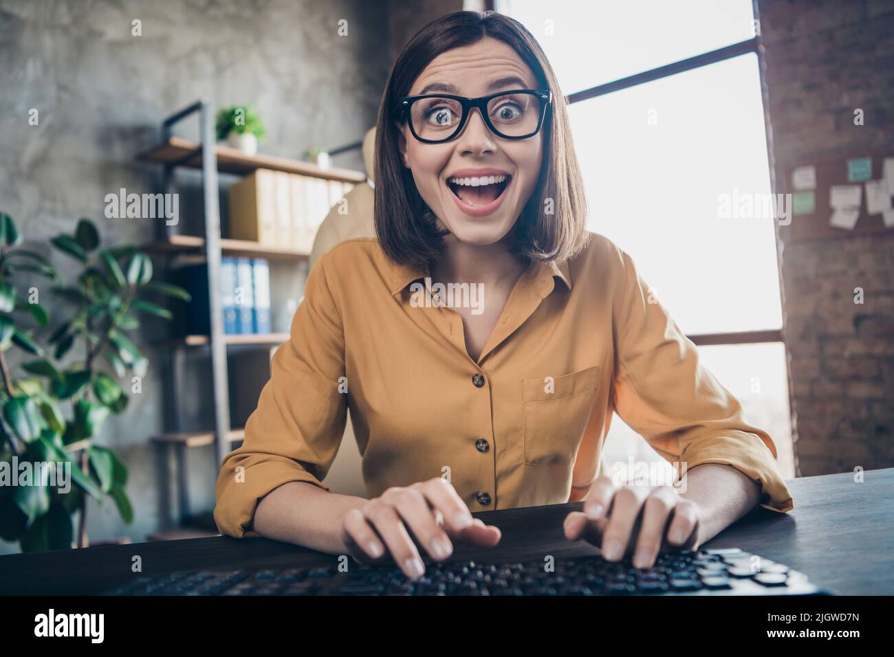 Portrait of funny crazy lady sitting chair keyboard writing coworking ...