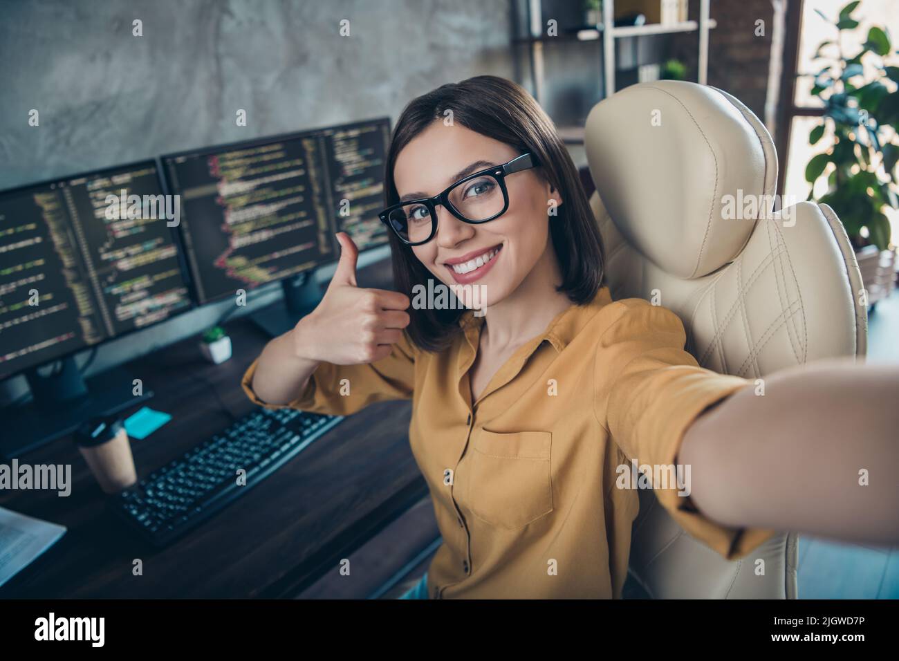 Self-portrait of attractive smart clever cheerful girl cyber engineer showing thumbup solution ...