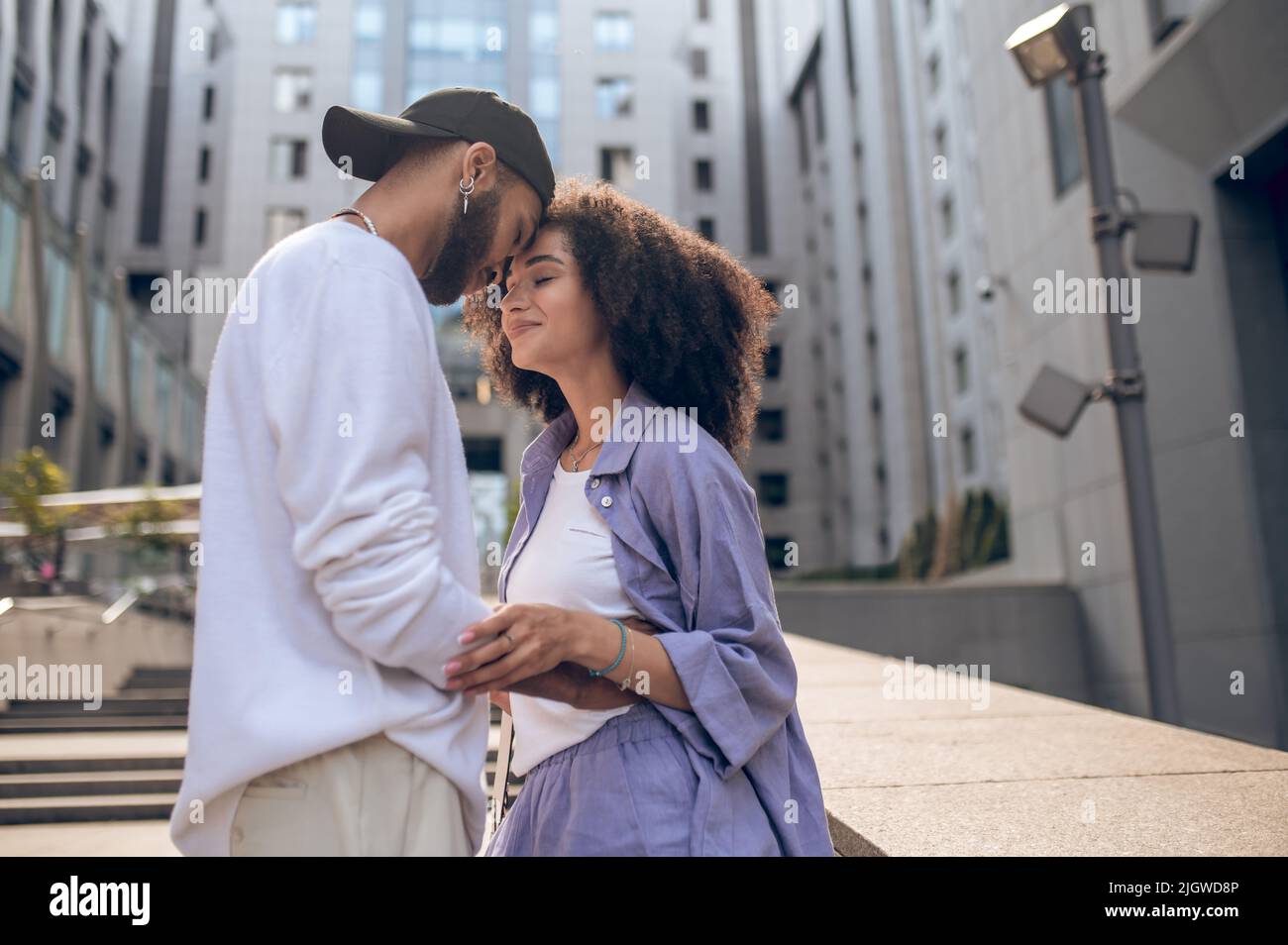 Happy couple in the street looking in love and exited Stock Photo - Alamy