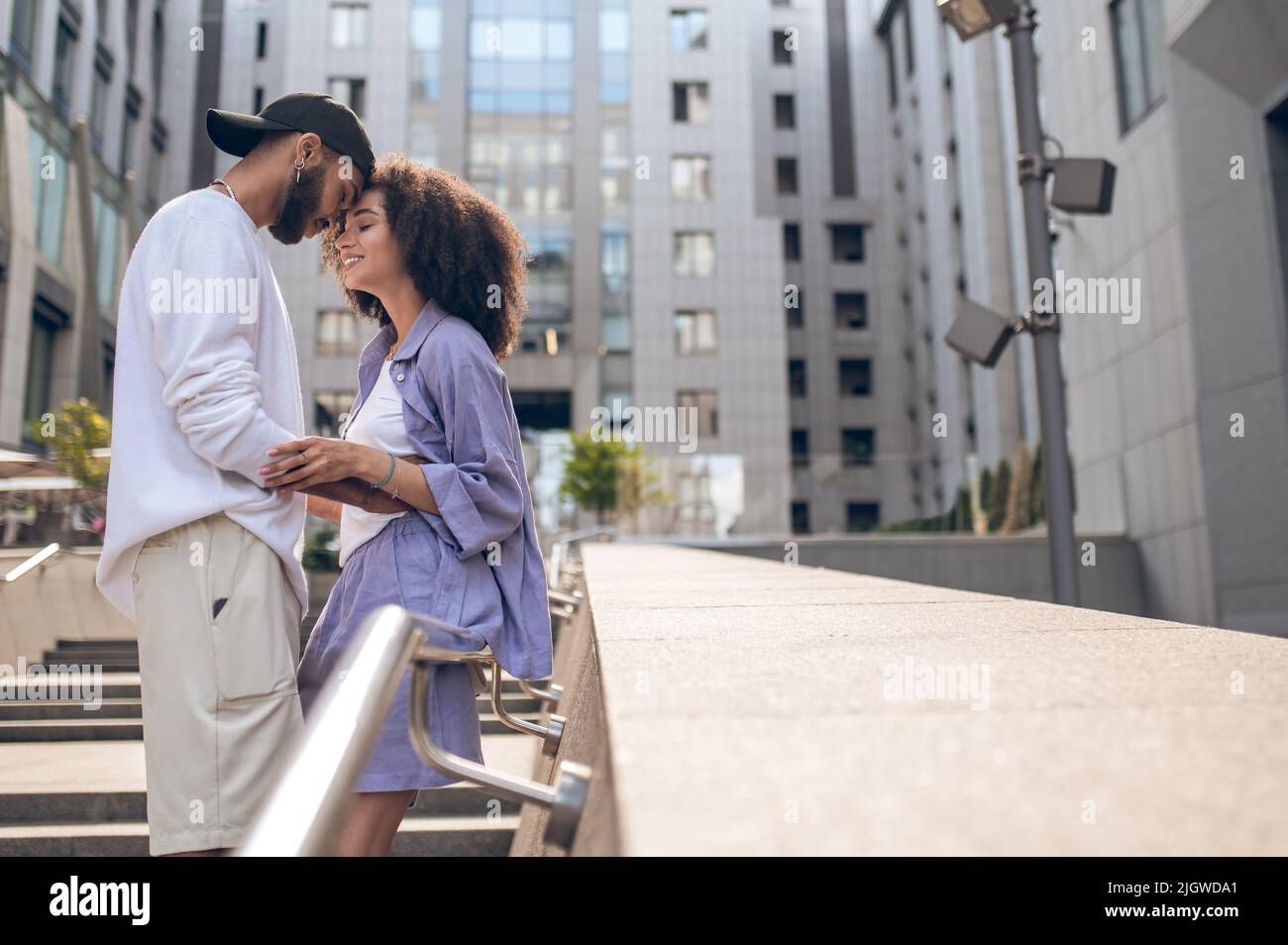 Happy couple in the street looking in love and exited Stock Photo - Alamy