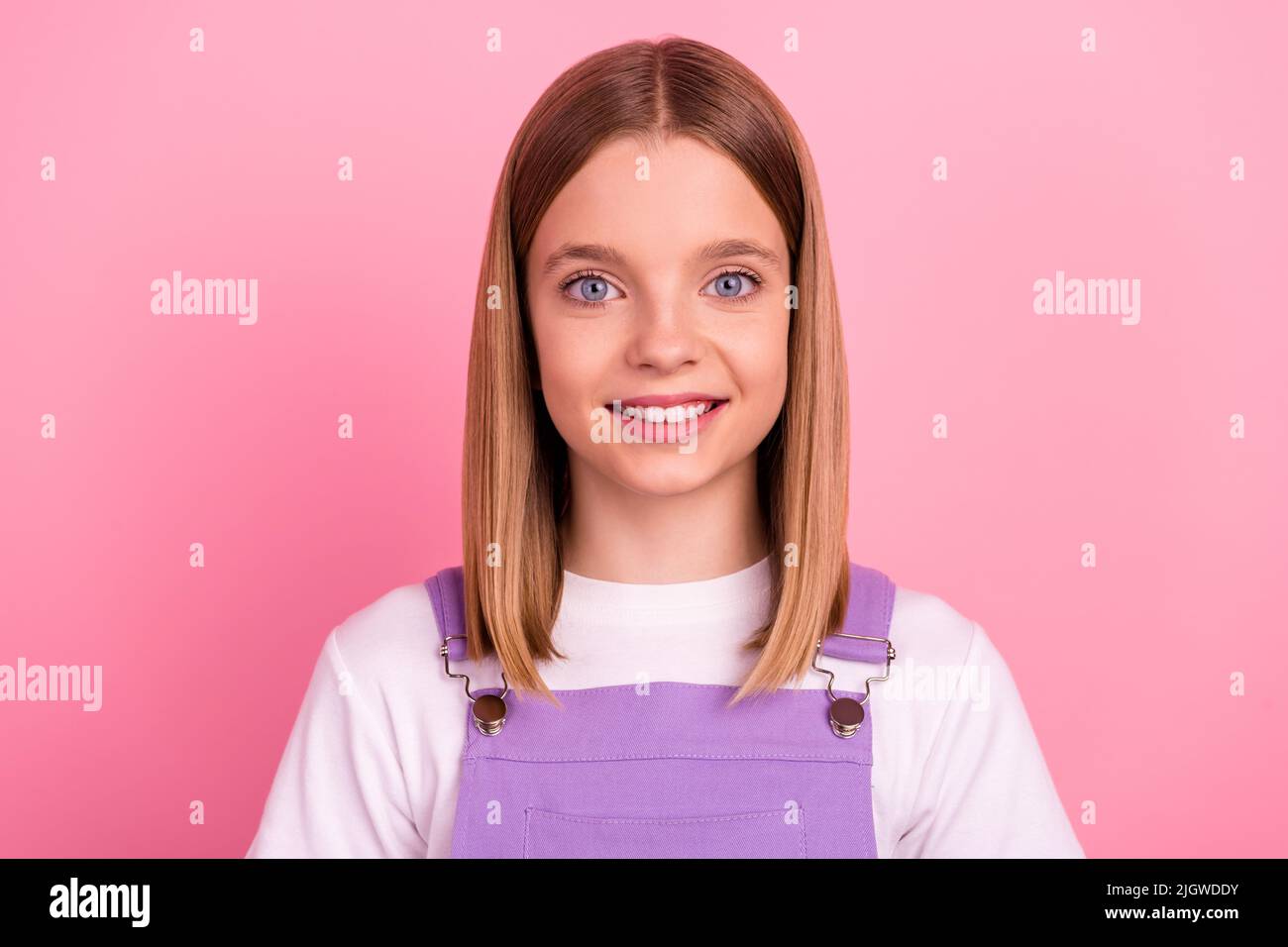 Portrait of young good looking sweet girl in violet overall visit kid ...