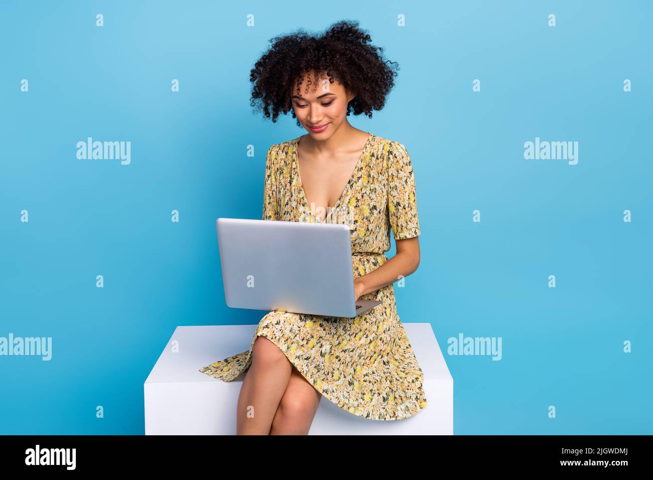 Photo of funny charming woman wear print dress sitting platform chair ...